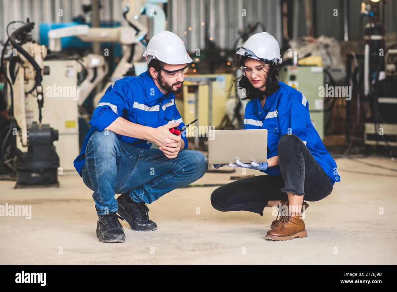 Engineers team mechanic using computer controller Robotic arm for ...