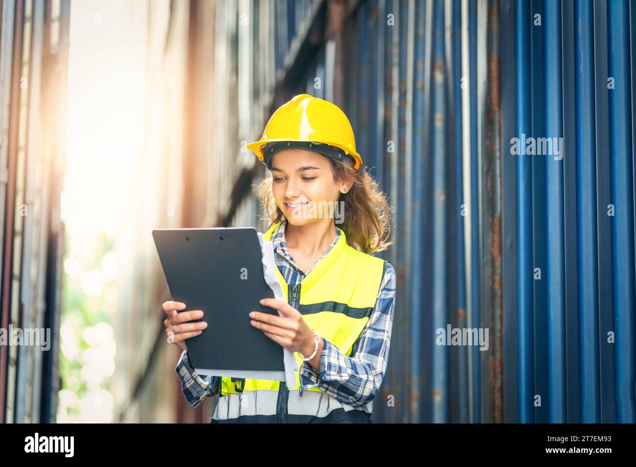 Women Engineer wears PPE checking container storage with cargo ...