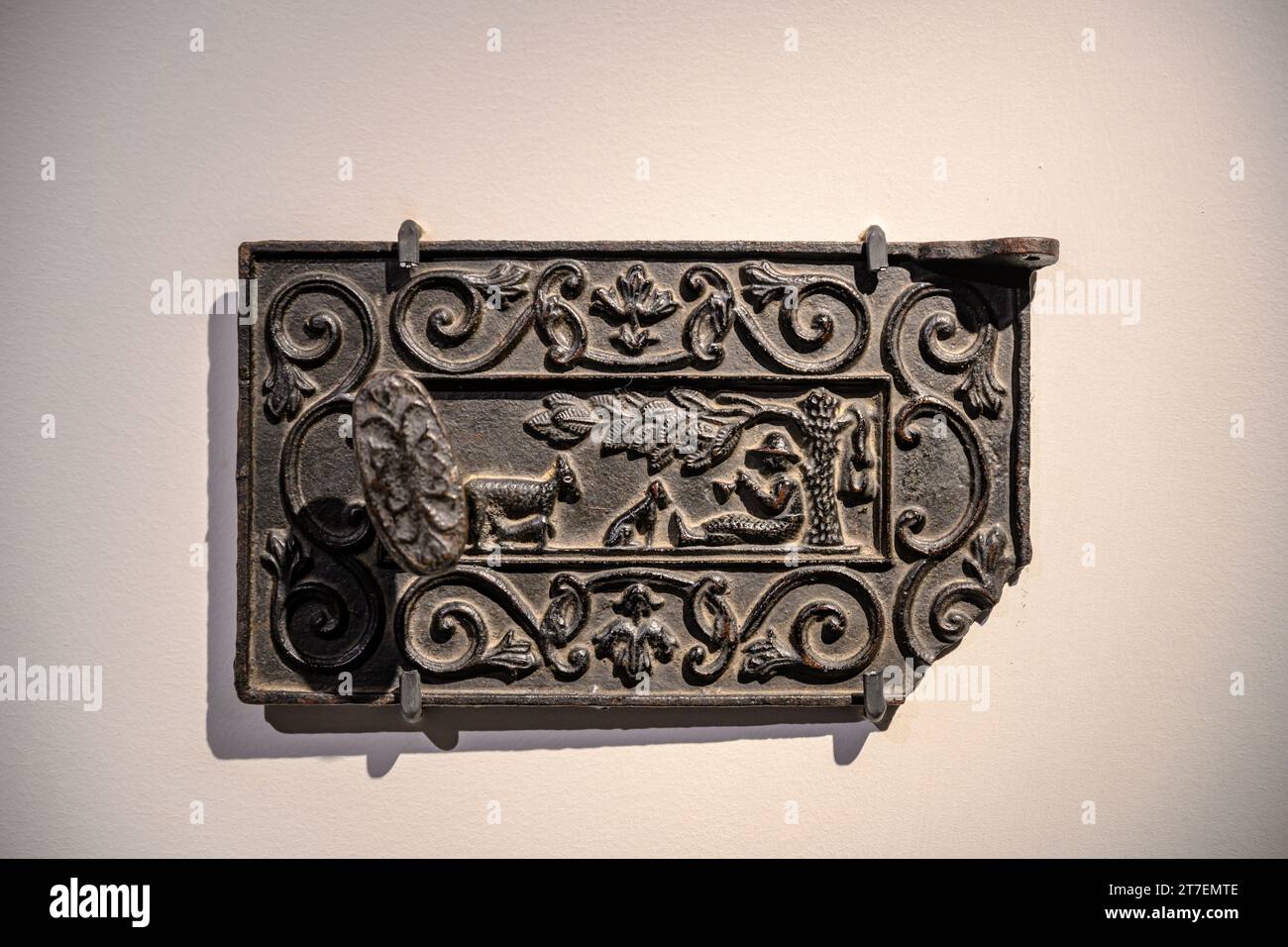 Medieval cast-iron stove door with bas-relief of shepherd, dog and ...