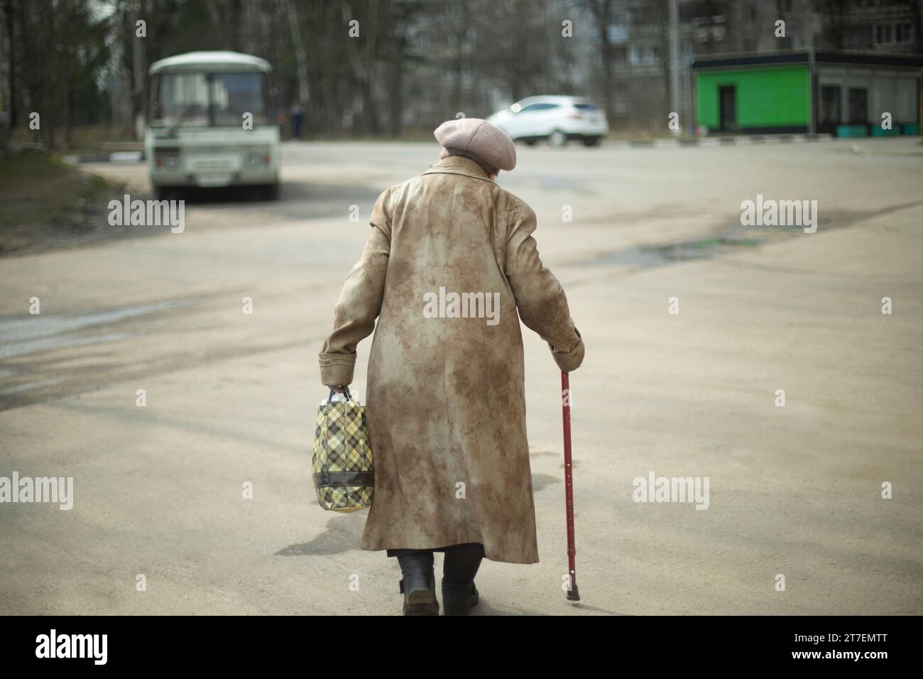 Elderly woman on street. Pensioner walks down road. Grandma with ...