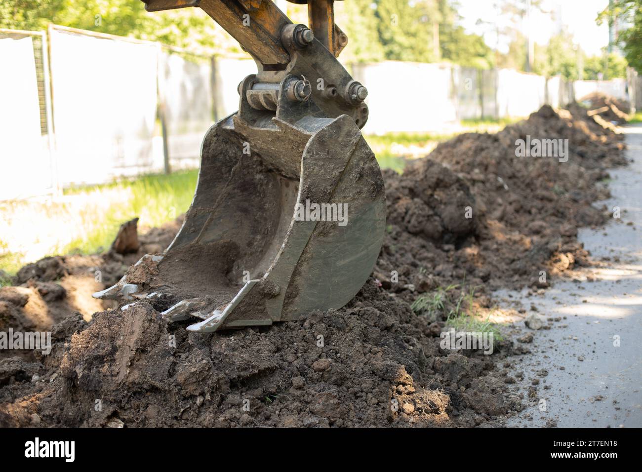 Escalator bucket digs ground. Heavy machinery at construction site ...