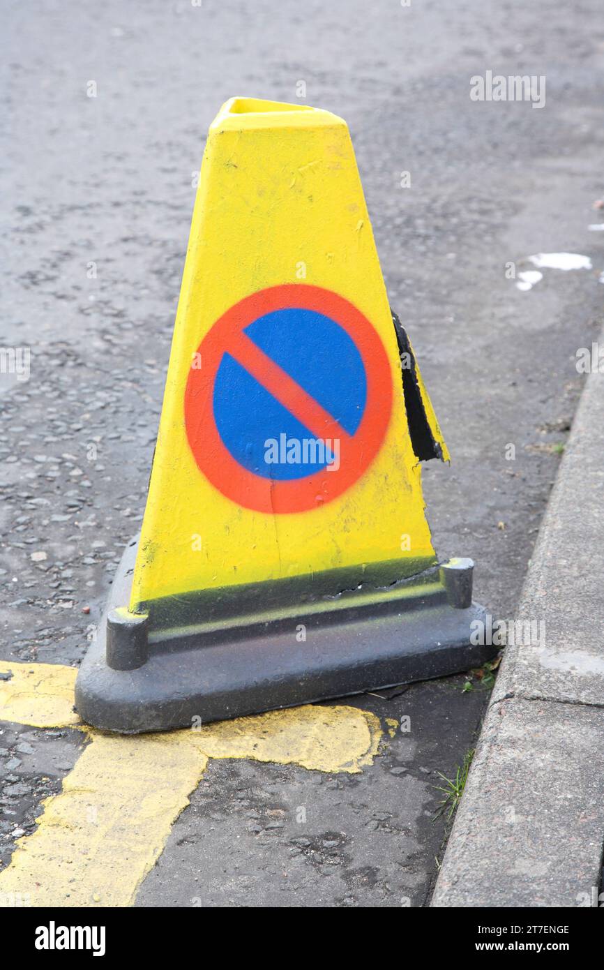single traffic cone next to double yellow lines on the road Stock Photo ...