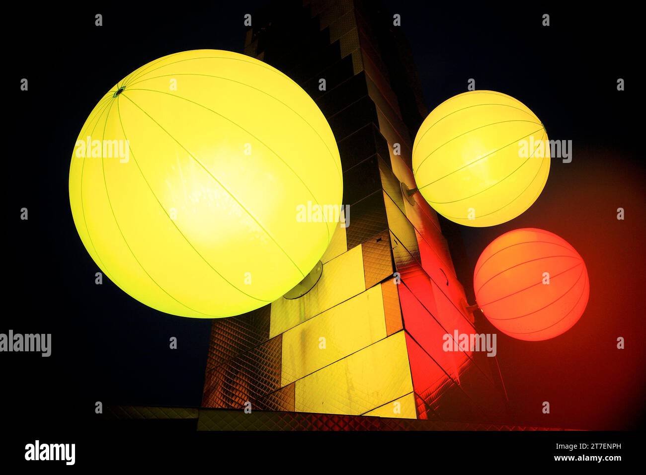 yellow and orange illuminated chinese lanterns close up against a ...
