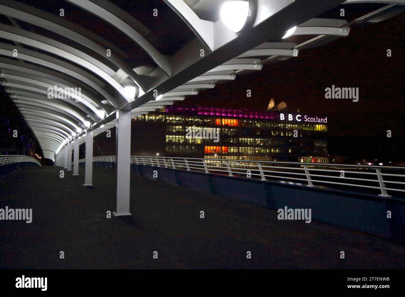 illuminated bells bridge in glasgow at night with bbc centre in the ...