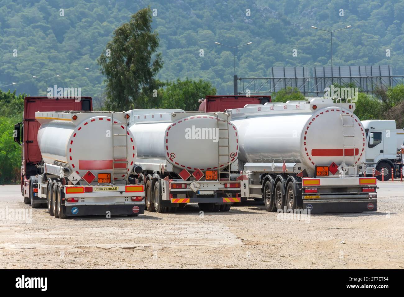 Parking row jam of trucks with fuel tanks in front of a warehouse and ...