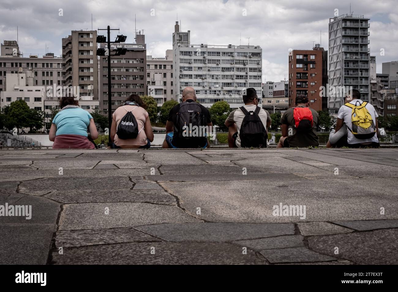 A group of backpacker tourists are sitting and resting on the tourist ...