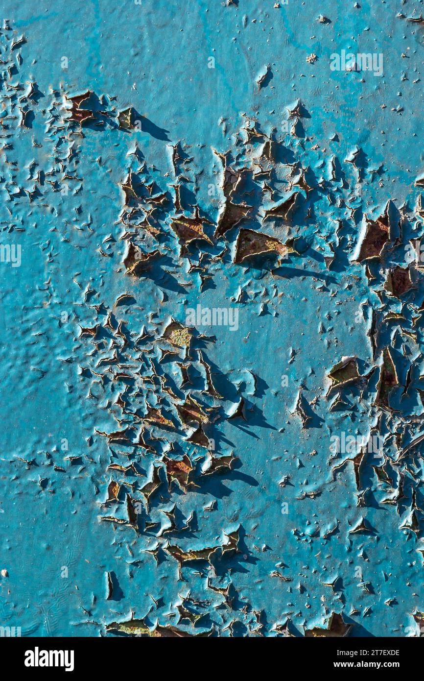 Blue peeling paint on the wall. Old concrete wall with cracked flaking ...