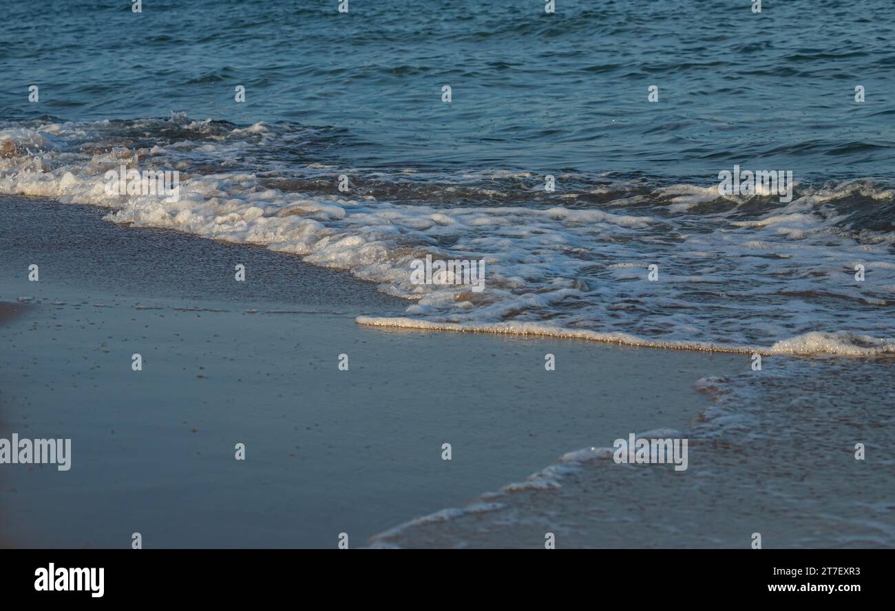 A large and strong storm wave of turquoise color with splashes of white ...
