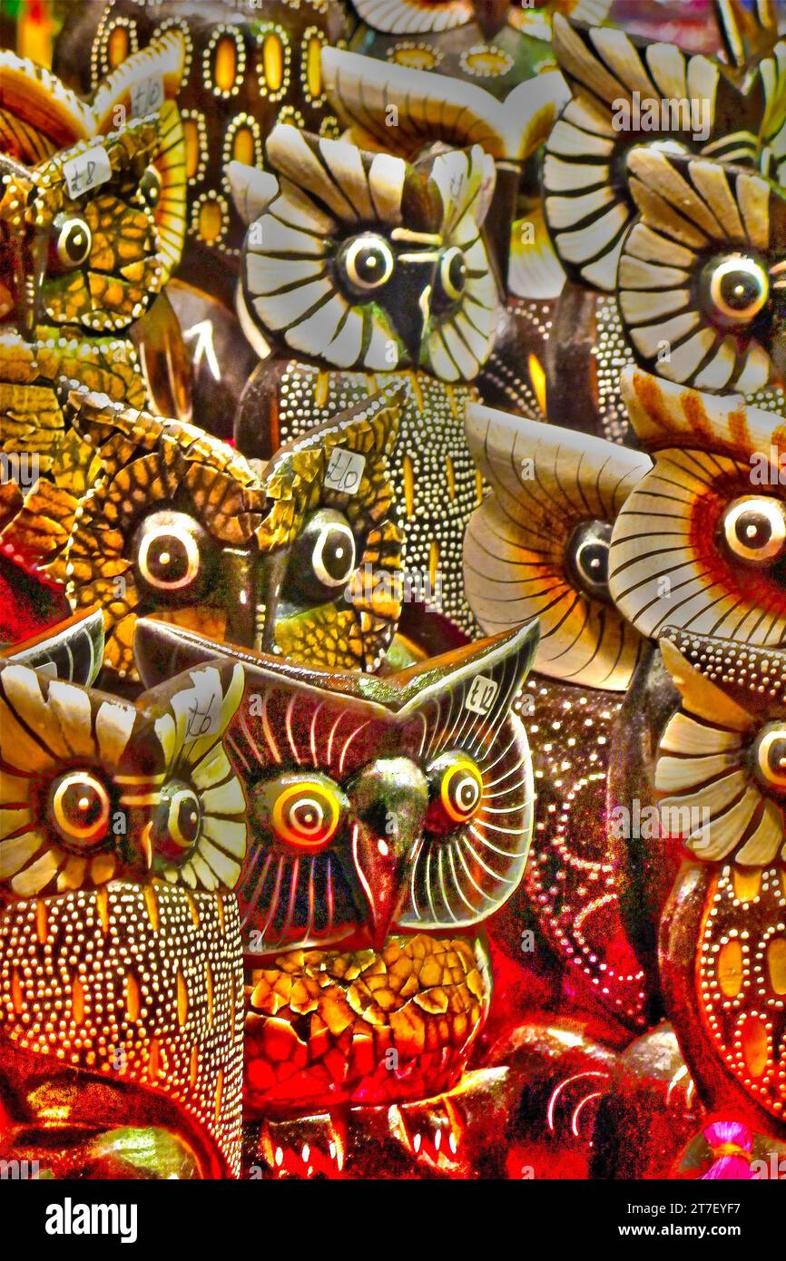 collection of saturated red tinted owl figures in the shop window ...