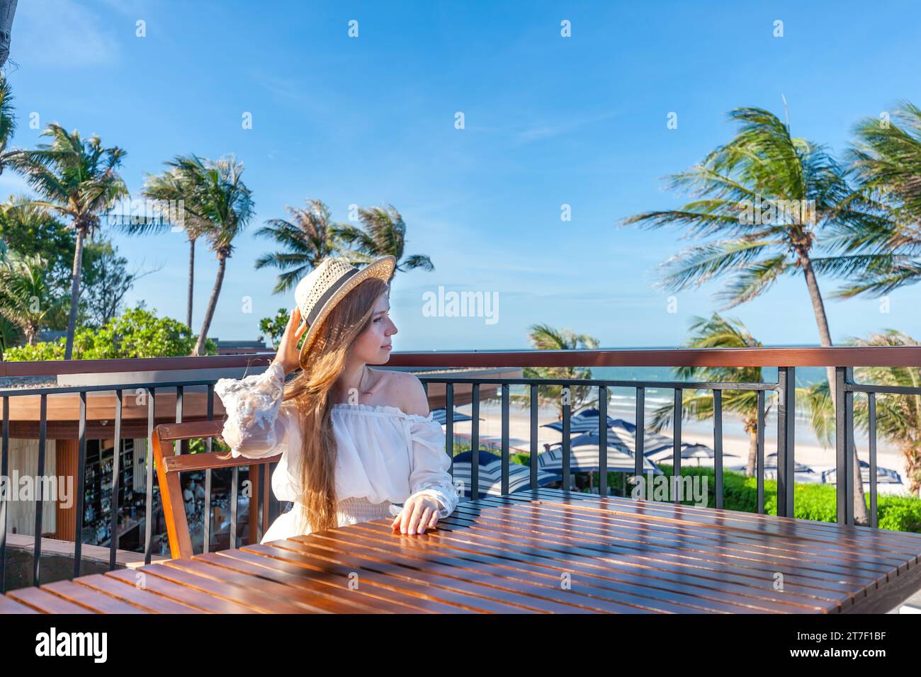 Gleaming sunlight on woman in straw hat, light dress Stock Photo - Alamy