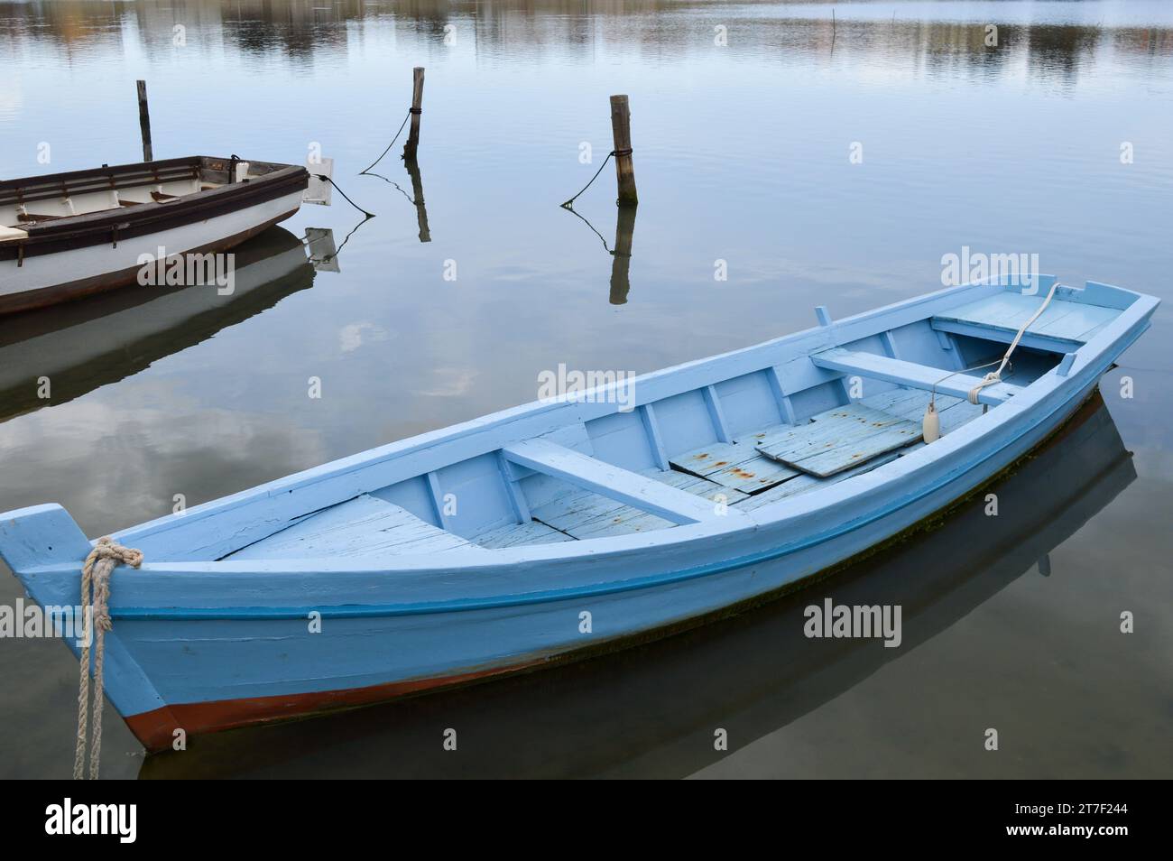 Old wooden traditional fishing boat in shallow water, authentic fishing ...