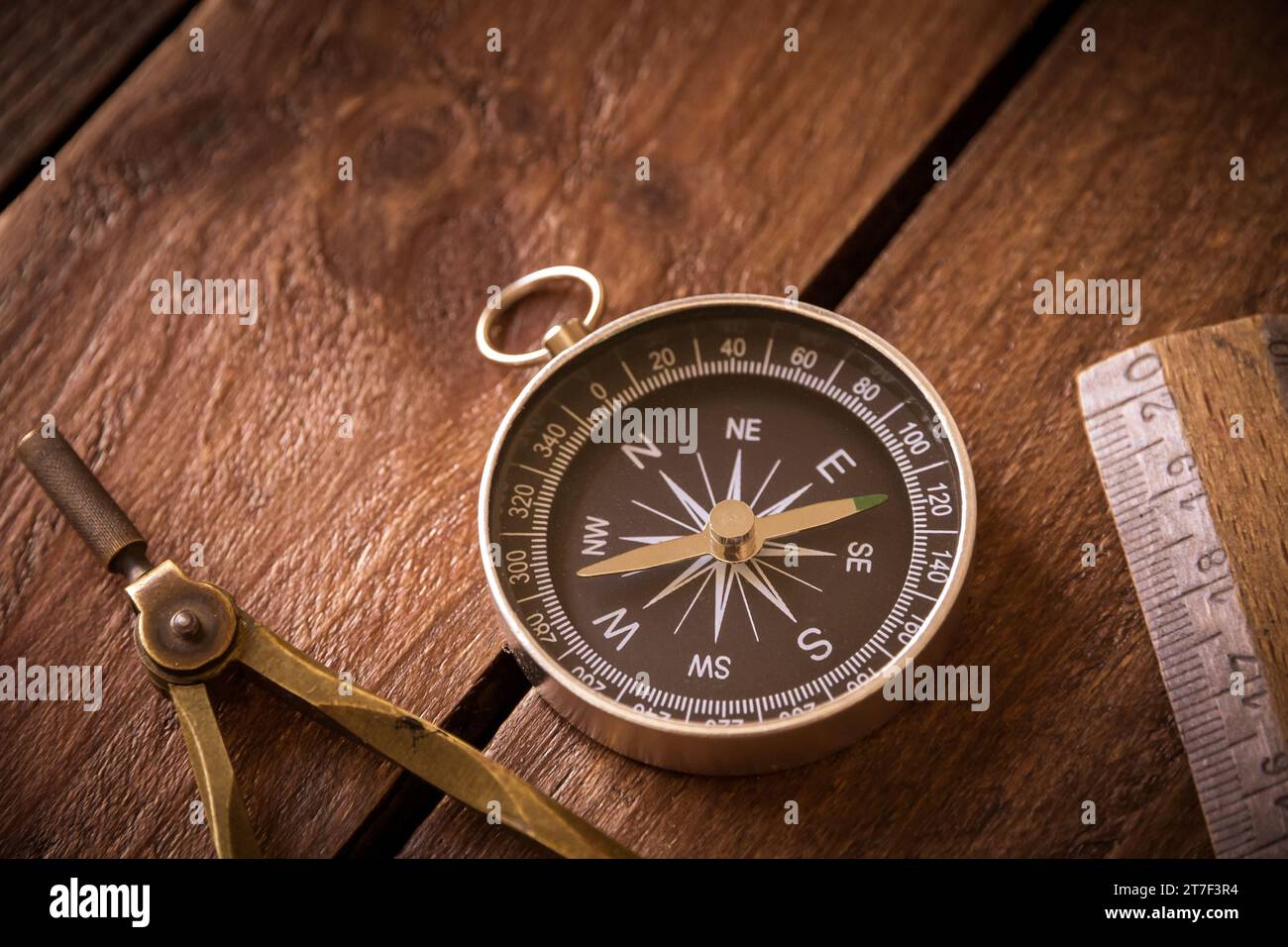 Vintage ruler, drawing and navigational Compass on a rustic wooden ...