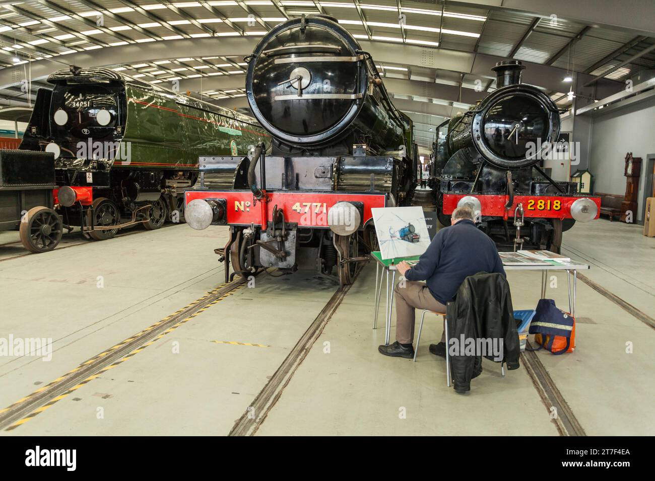 A male artist sat down sketchig the trains at the Locomotion, National ...