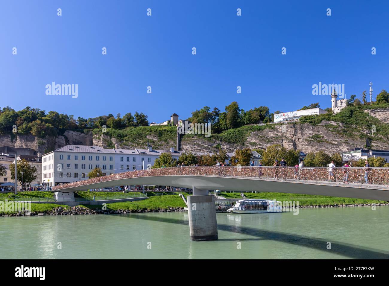 Tourists on Marko Feingold footbridge over Salzach river in Salzburg ...