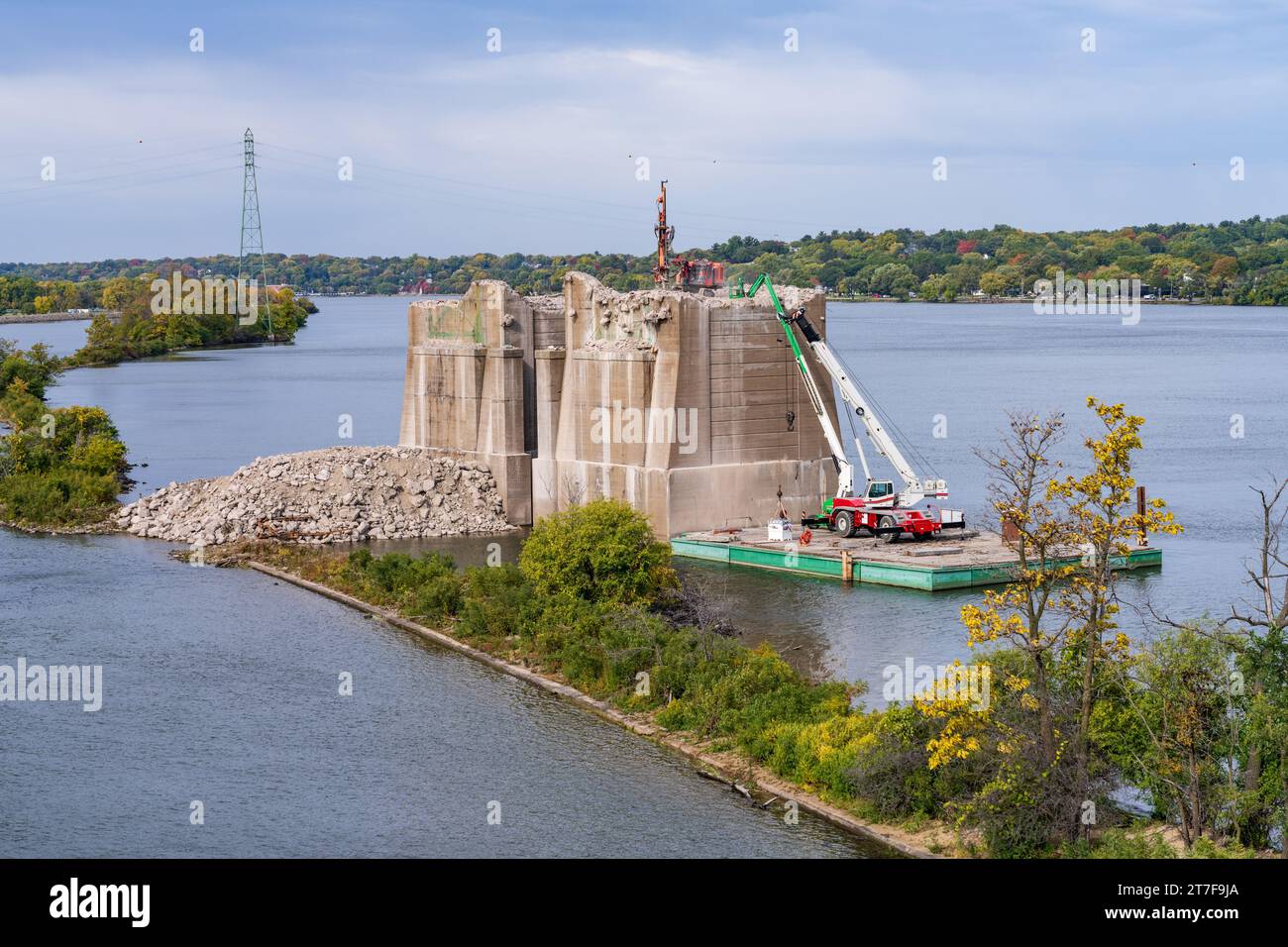 Heavy machinery removes the concrete pillars of historic I-74 bridge ...