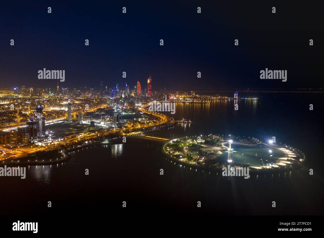 A nighttime view of a bustling city skyline, illuminated by the lights ...