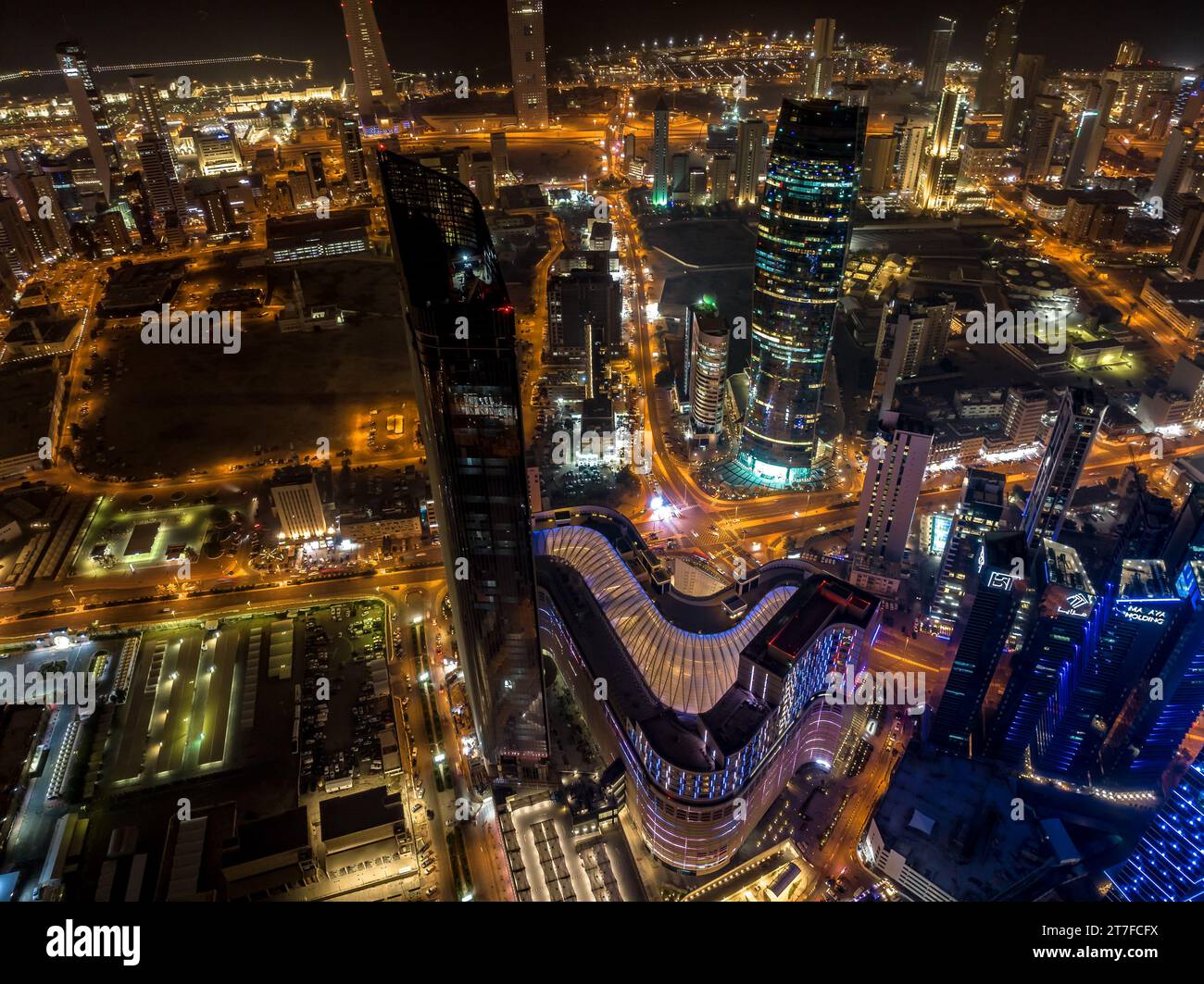 A nighttime view of a bustling city skyline, illuminated by the lights ...