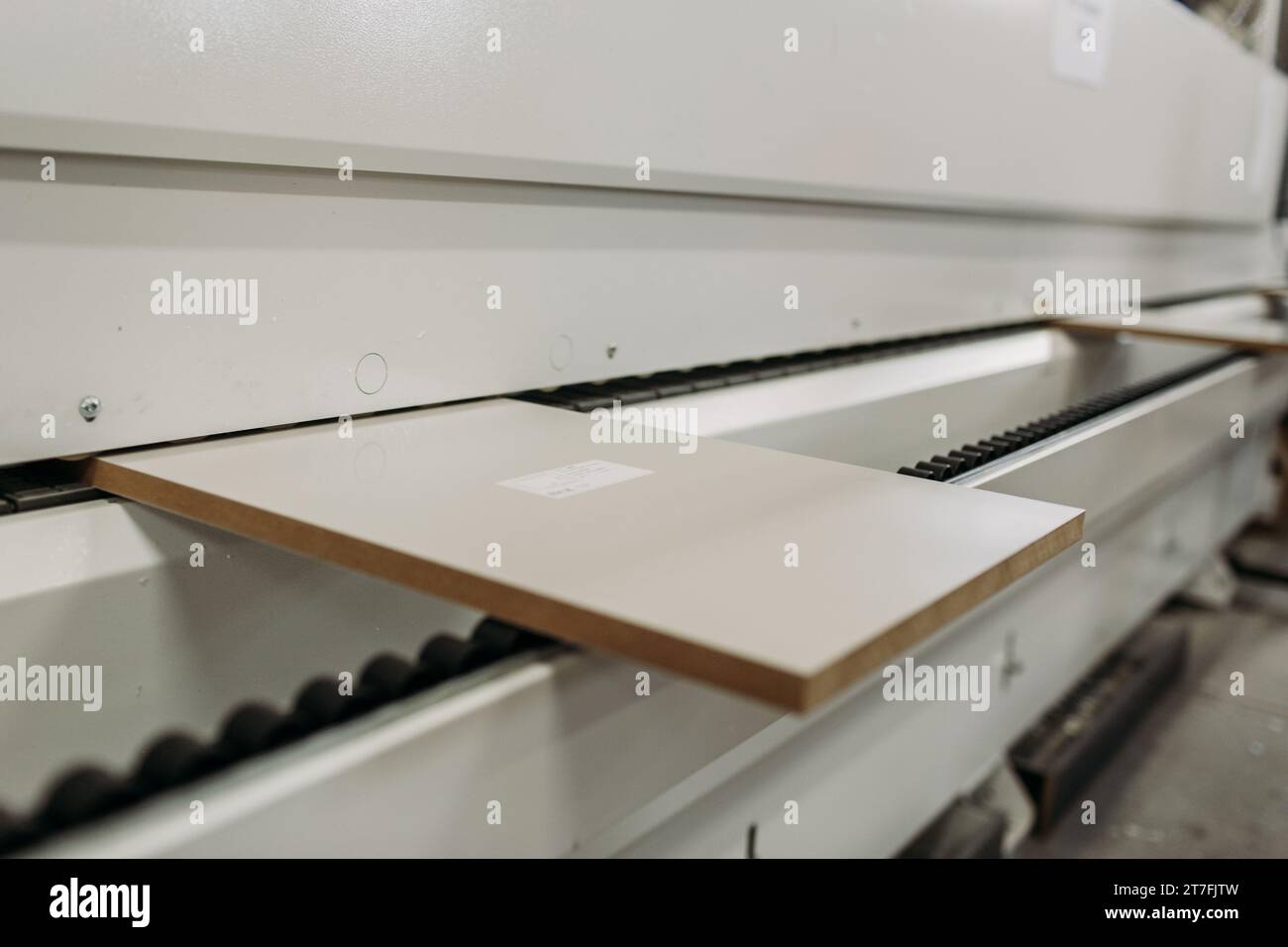 Furniture factory. Wooden MDF parts moving along a specially equipped ...