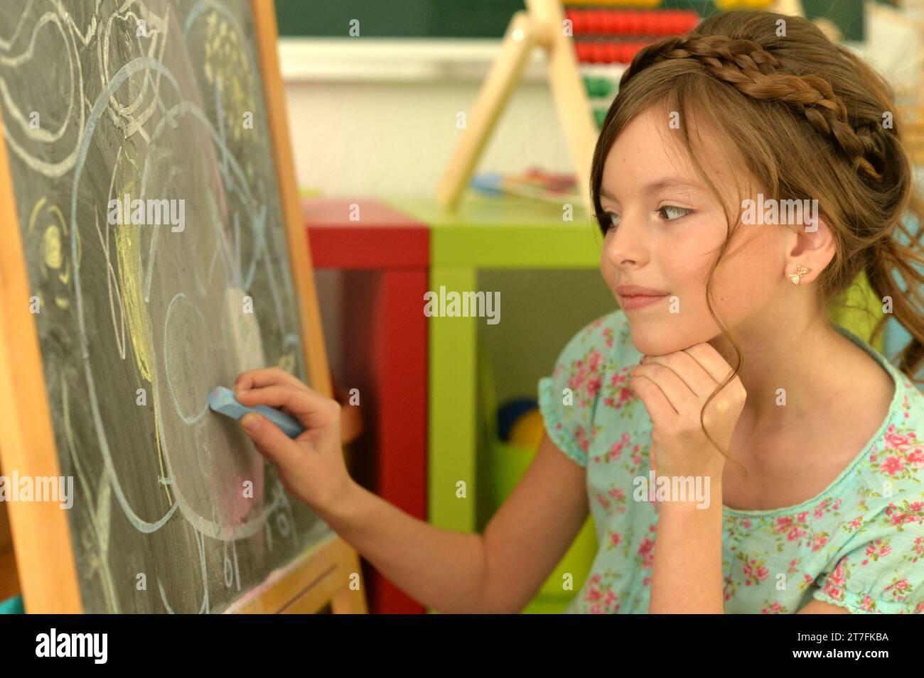 Sweet little girl learning happily in front of her blackboard Stock ...