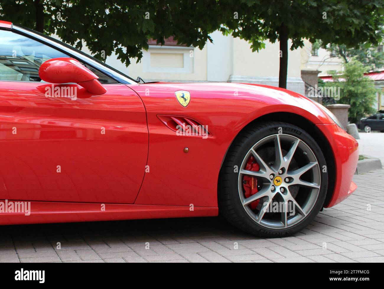 Two Ferrari automobiles parked outdoors in a street, one with the ...