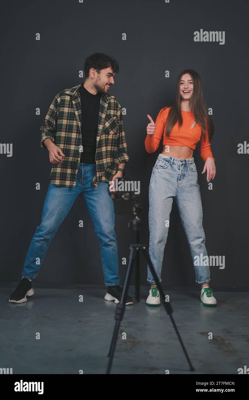 Young smiling couple recording video while dancing at home, having fun ...
