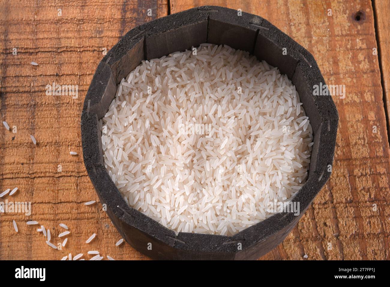 white rice natural long rice grain uncooked healthy food wooden table ...