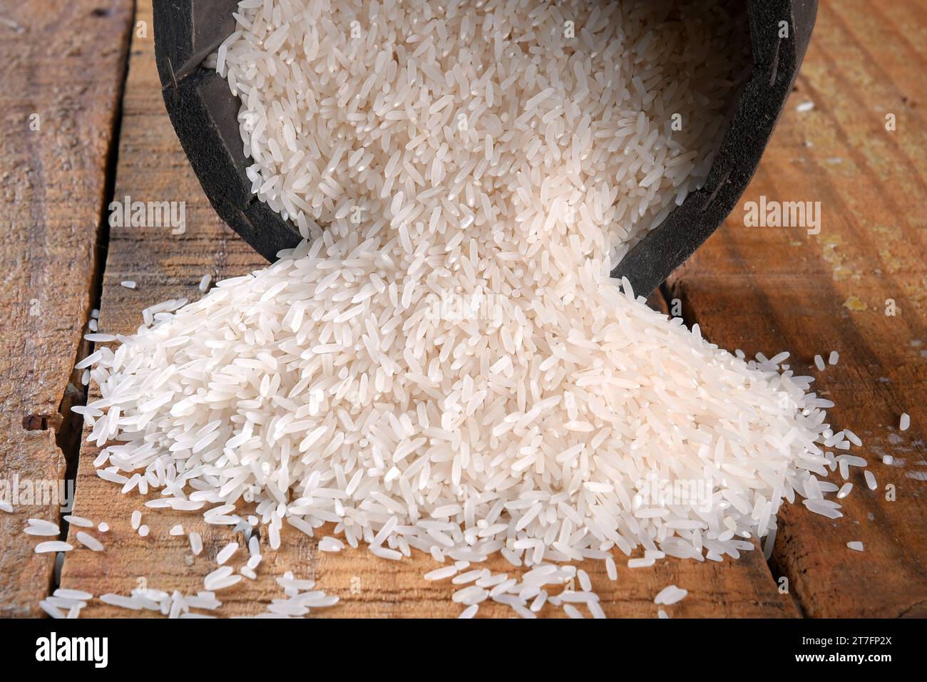white rice natural long rice grain uncooked healthy food wooden table ...