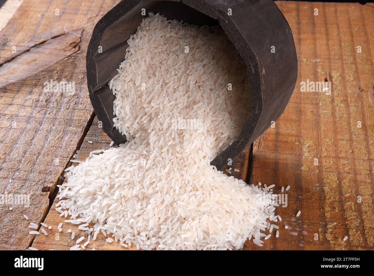 white rice natural long rice grain uncooked healthy food wooden table ...