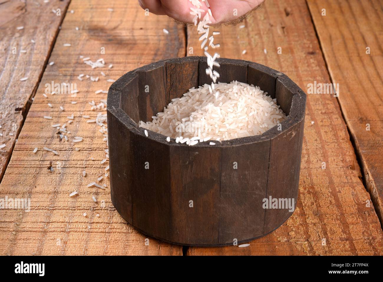 white rice natural long rice grain uncooked healthy food wooden table ...