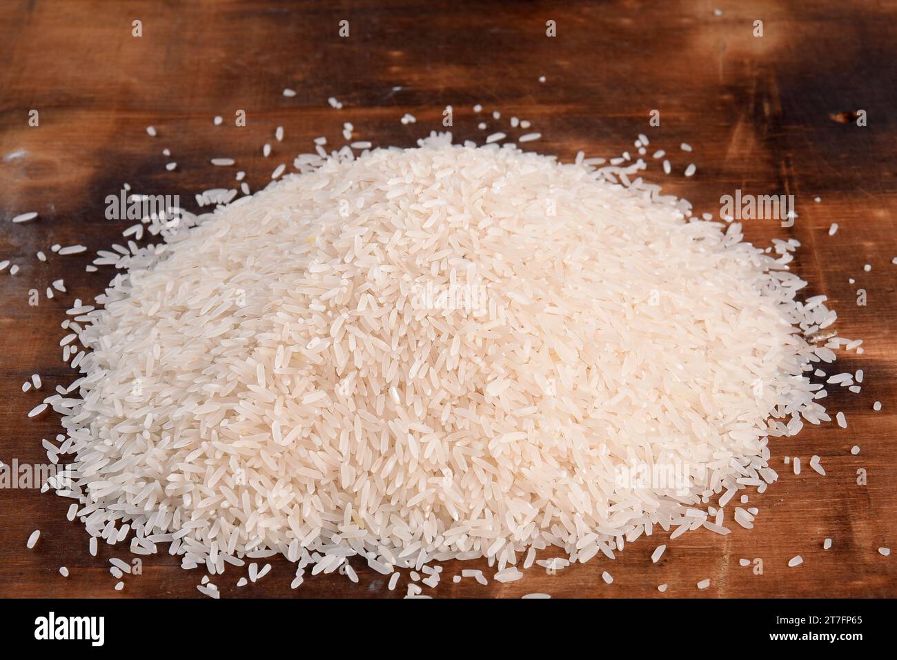 white rice natural long rice grain uncooked healthy food wooden table ...