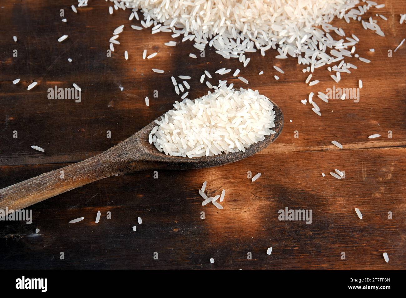 white rice natural long rice grain in wooden spoon use texture ...