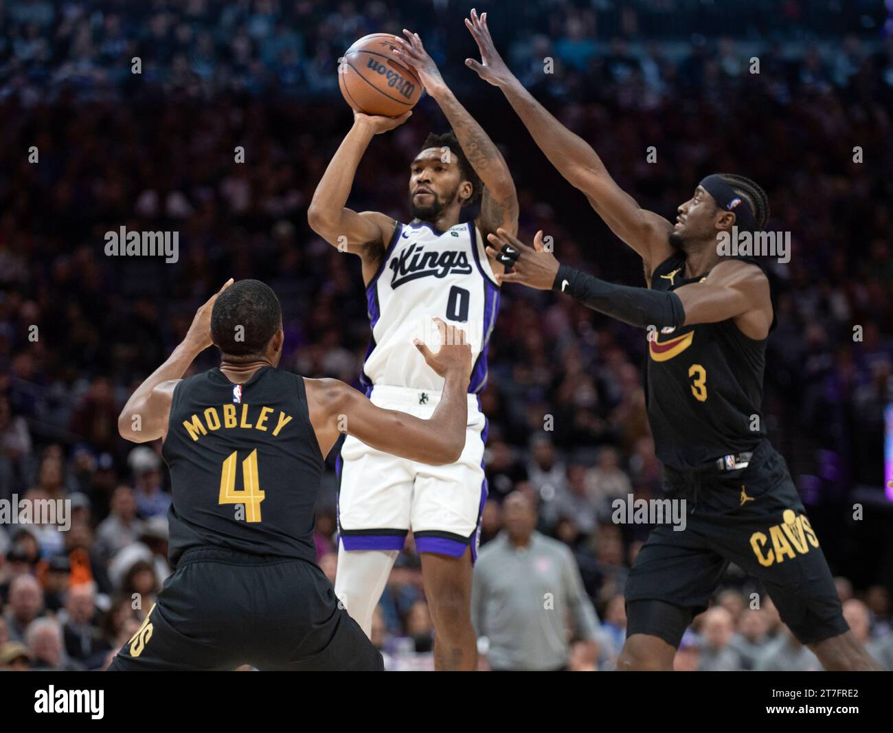 Sacramento Kings guard Malik Monk (0) puts up a shot between Cleveland ...
