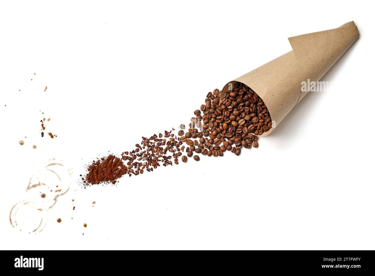 Roasted coffee beans in a bag made of craft paper, poured onto a white ...
