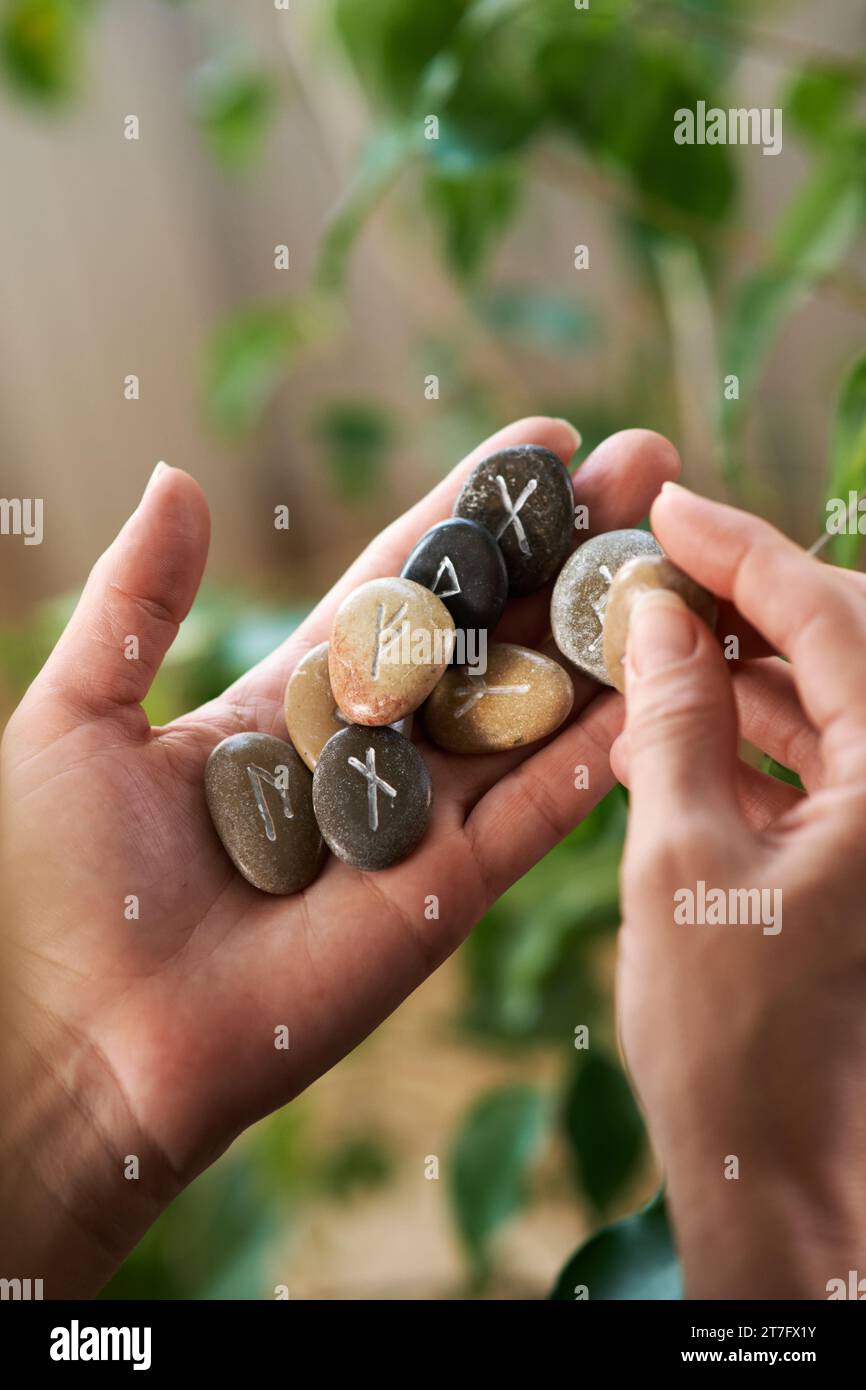 stone runes in a woman's hand Stock Photo - Alamy