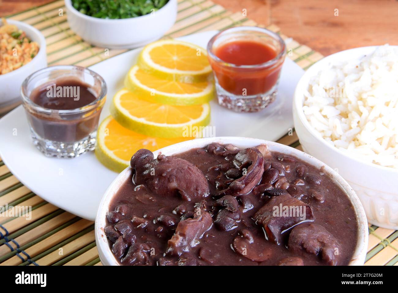 traditional Brazilian food feijoada with beans, pork, bacon, sausage ...