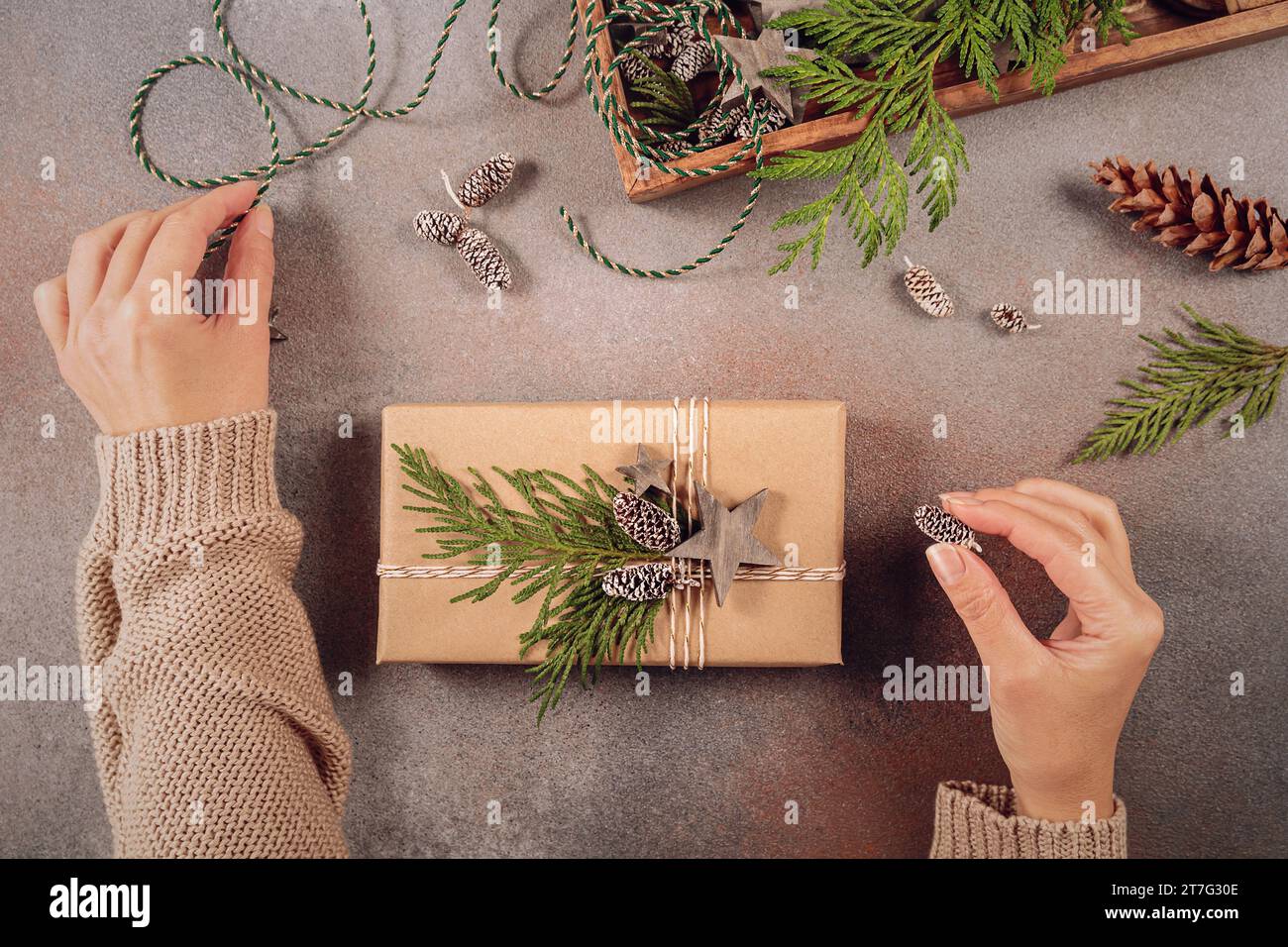 Christmas decor and Womans hands decorating handmade gift box Stock ...