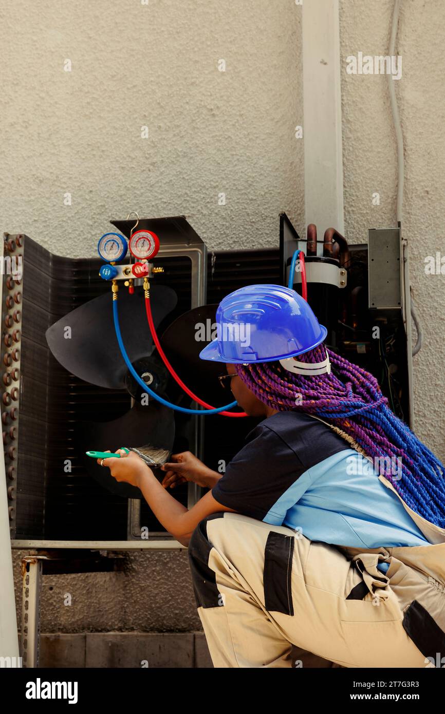 Knowleadgeable engineer removing layer of dust from blower fan to ...