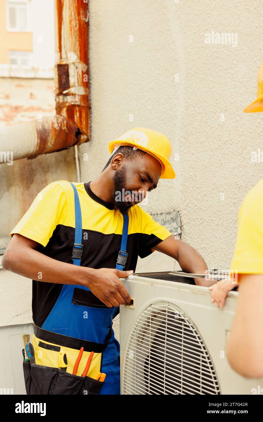 Competent mechanic and expert repairman disassembling old broken air ...