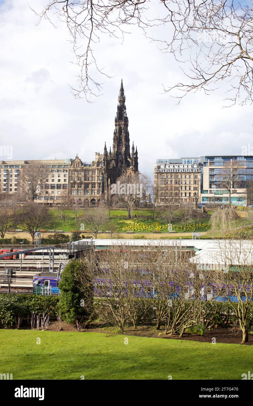 view of princess street in edinburgh with railway lines and trains in ...