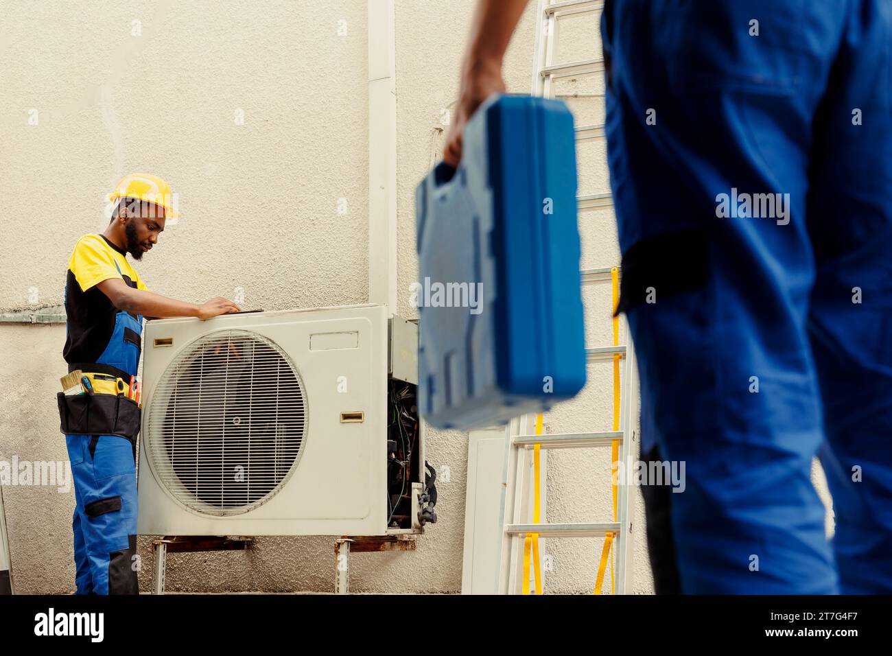 Engineer arriving on location to help apprentice mend busted electric ...