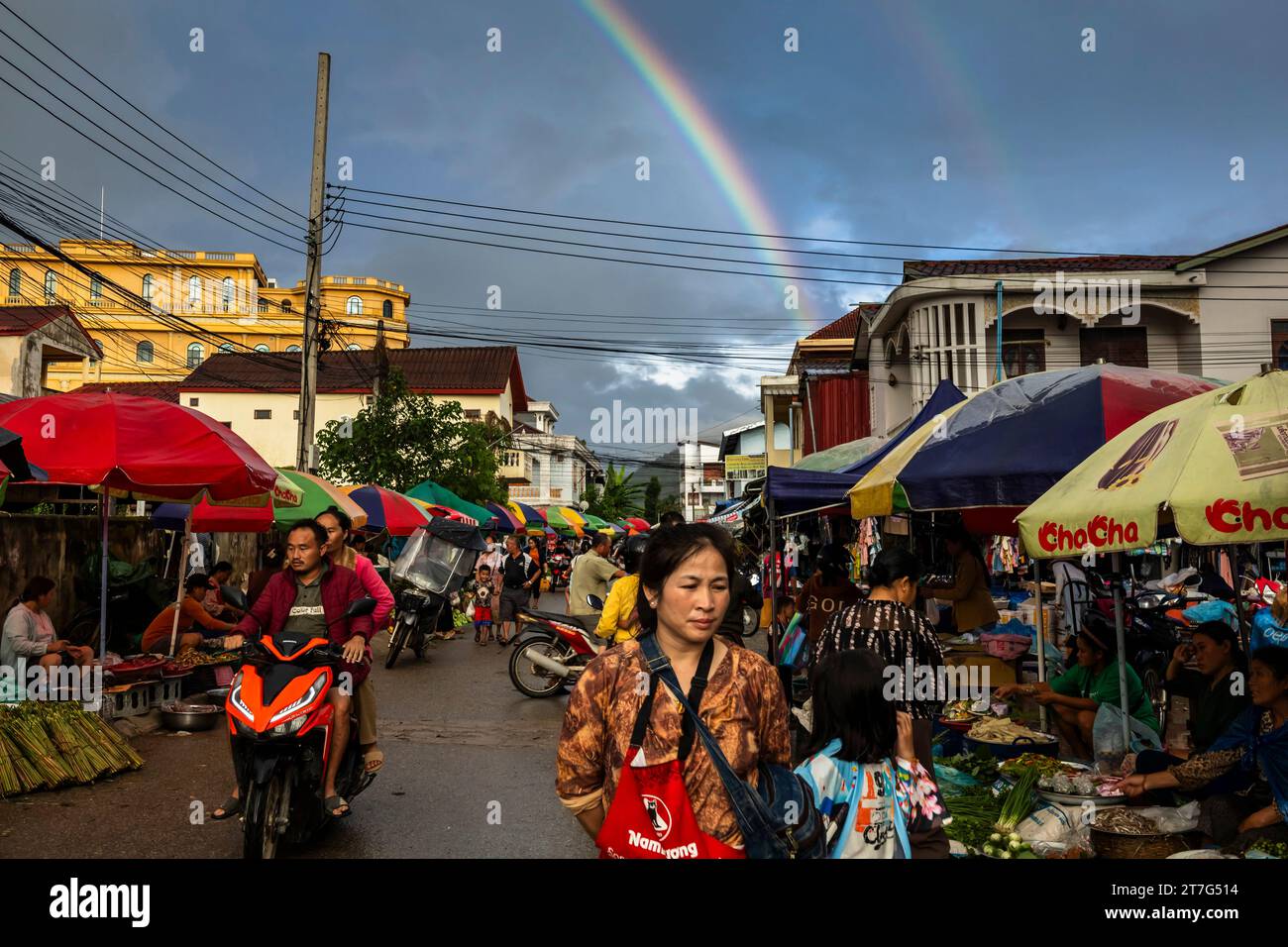 Rainbow after rain, street of central market, city center, Phonsavan ...