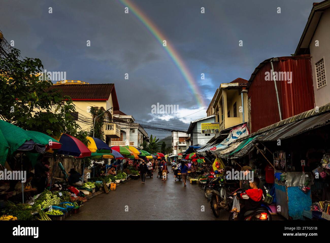 Rainbow after rain, street of central market, city center, Phonsavan ...
