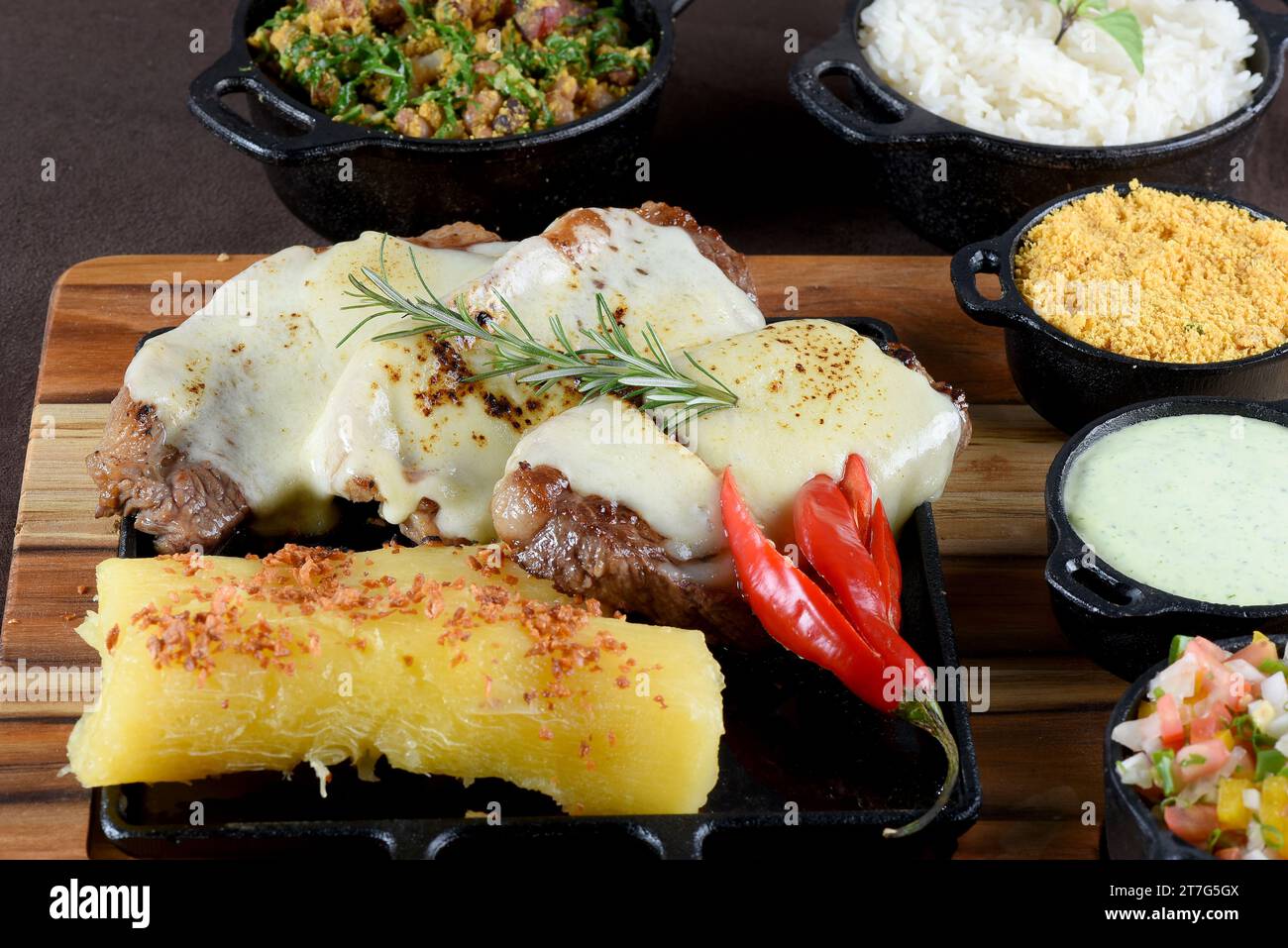 barbecued meat with cassava fried banana rice beans and herb sauce ...