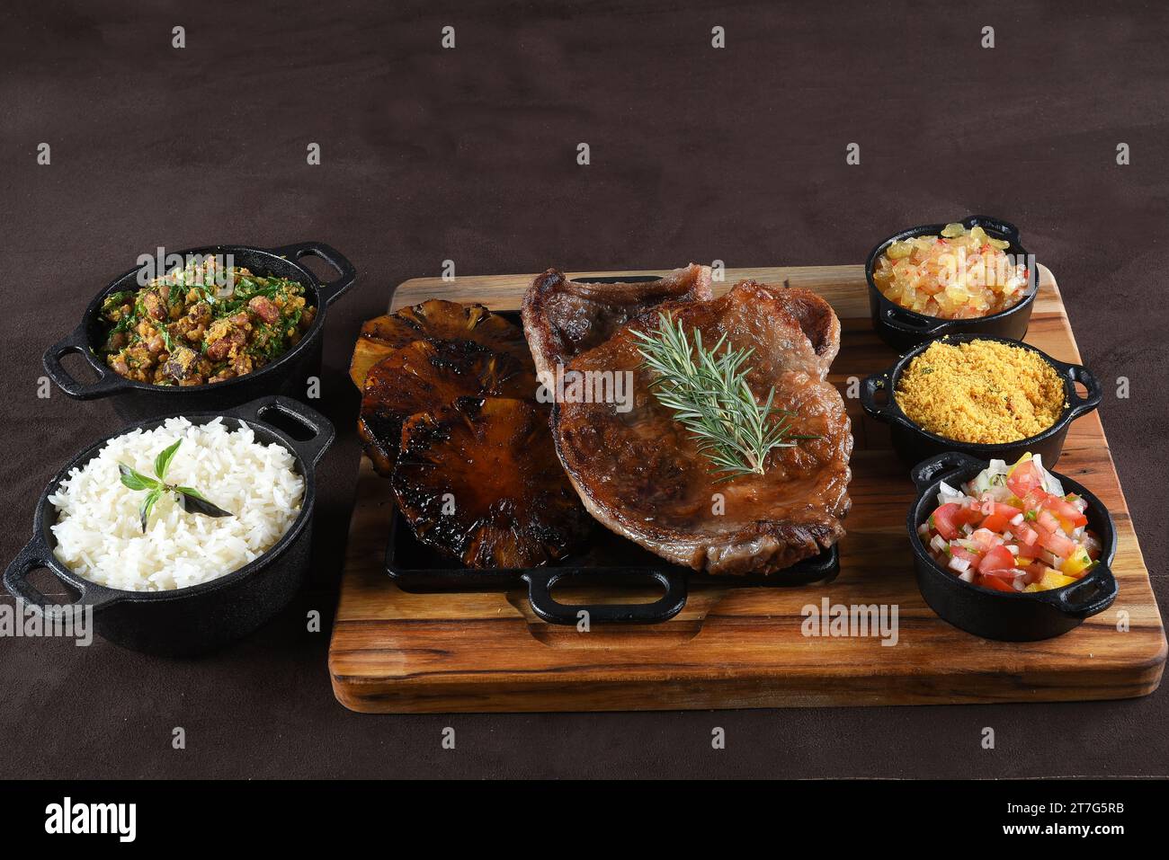 barbecued meat with cassava fried banana rice beans and herb sauce ...