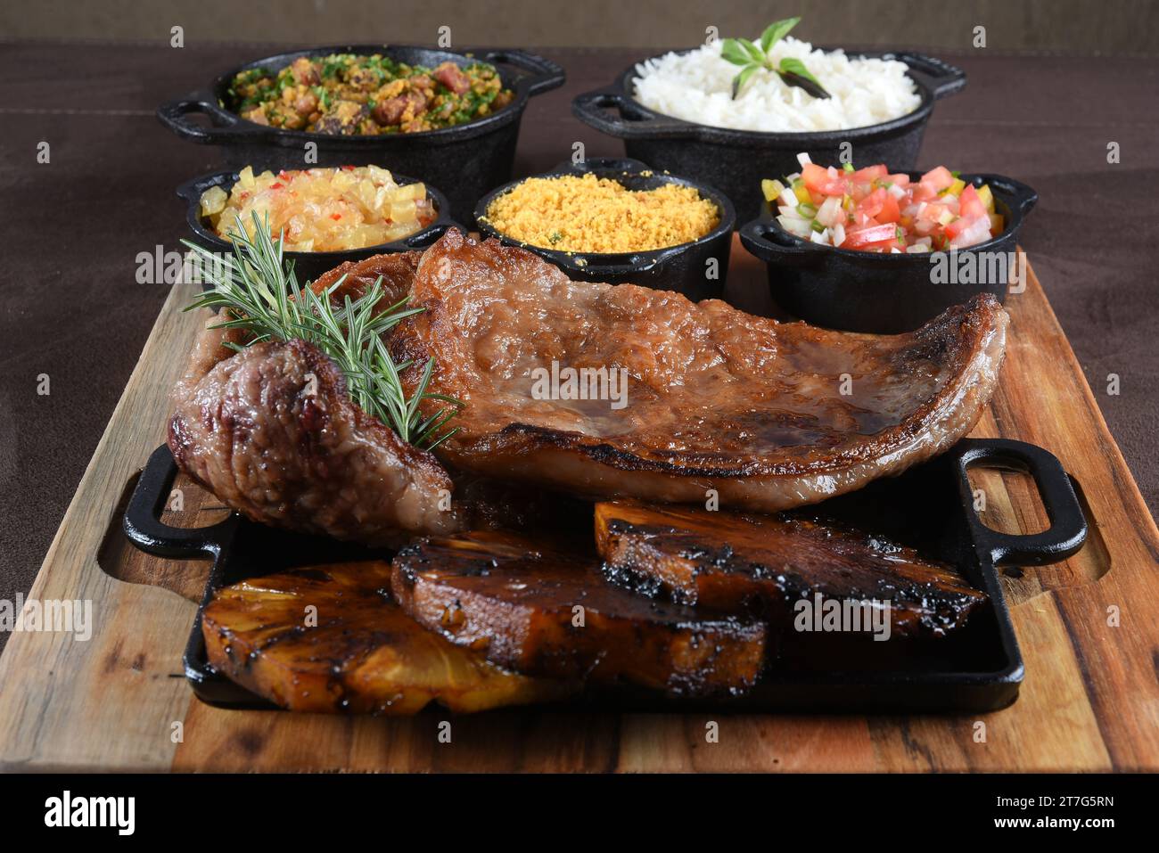 barbecued meat with cassava fried banana rice beans and herb sauce ...