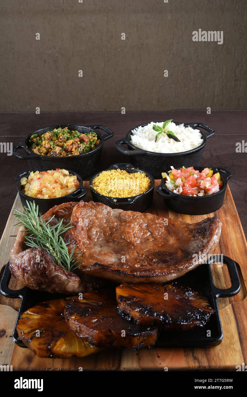 barbecued meat with cassava fried banana rice beans and herb sauce ...