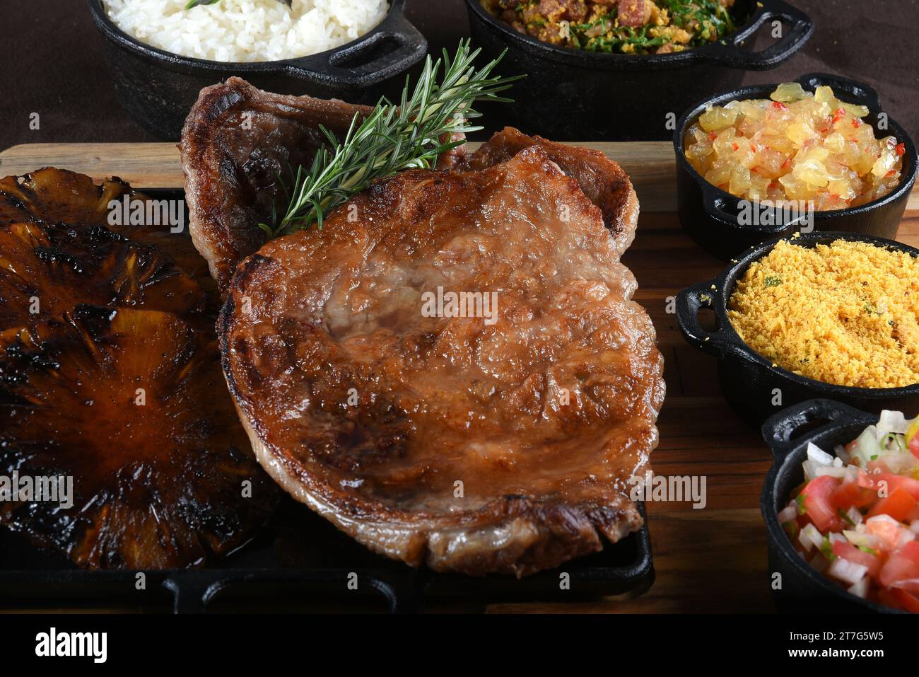 barbecued meat with cassava fried banana rice beans and herb sauce ...