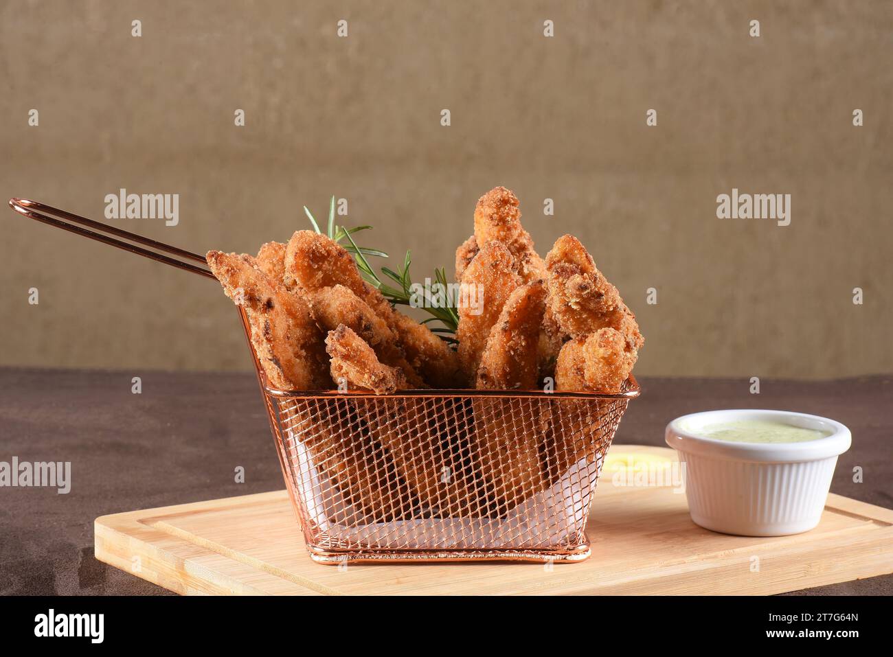 pieces of fried fish breaded with panko flour served with herb sauce ...