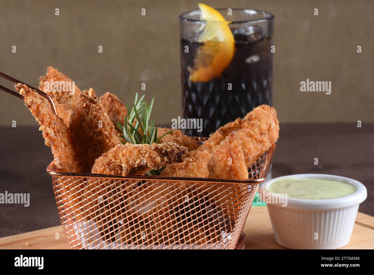 portion of fried fish, fried chicken strips inside metal basket tasty ...