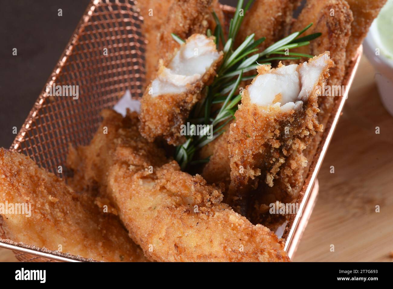 portion of fried fish, fried chicken strips inside metal basket tasty ...
